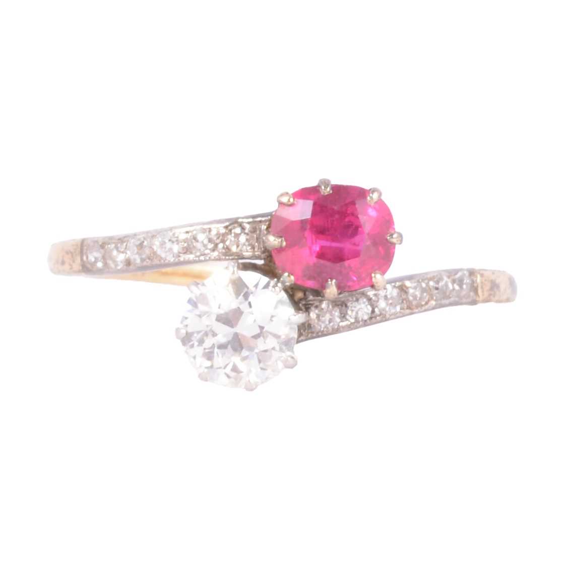 Lot 9 - A ruby and diamond crossover ring.