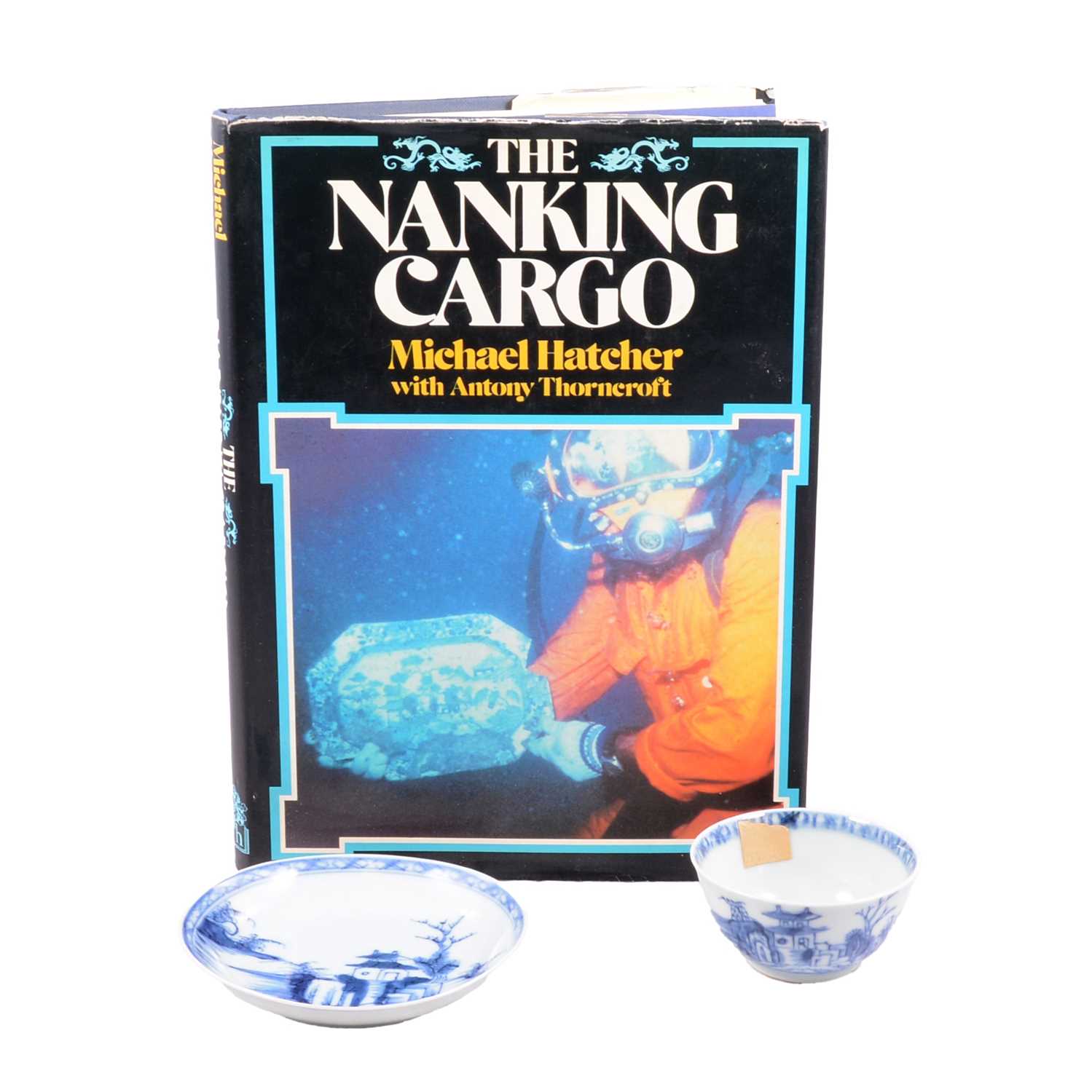 Lot 127 - Nanking Cargo tea bowl and saucer, with book,