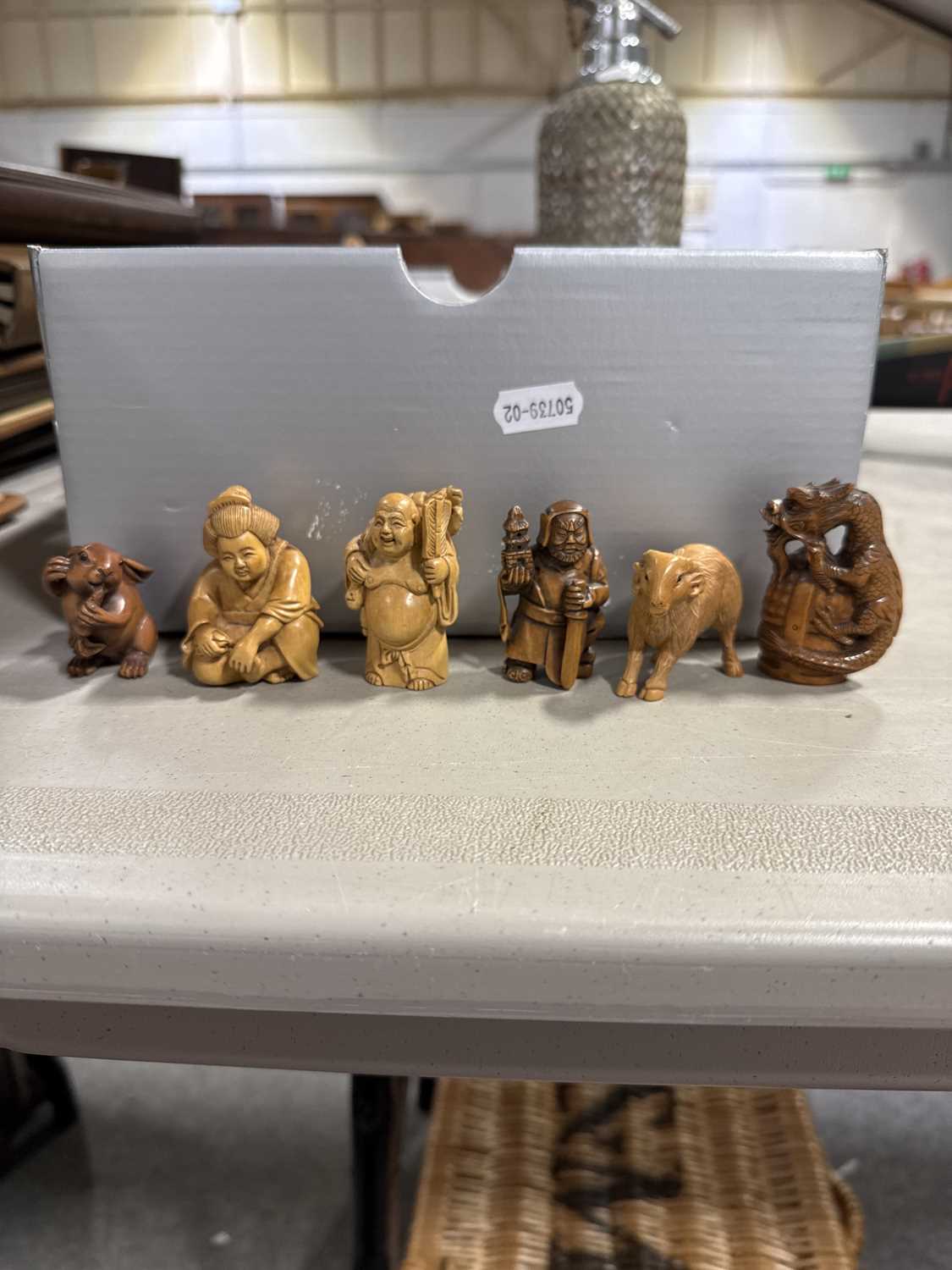 Lot 154 - Eighteen Japanese carved wood netsuke,