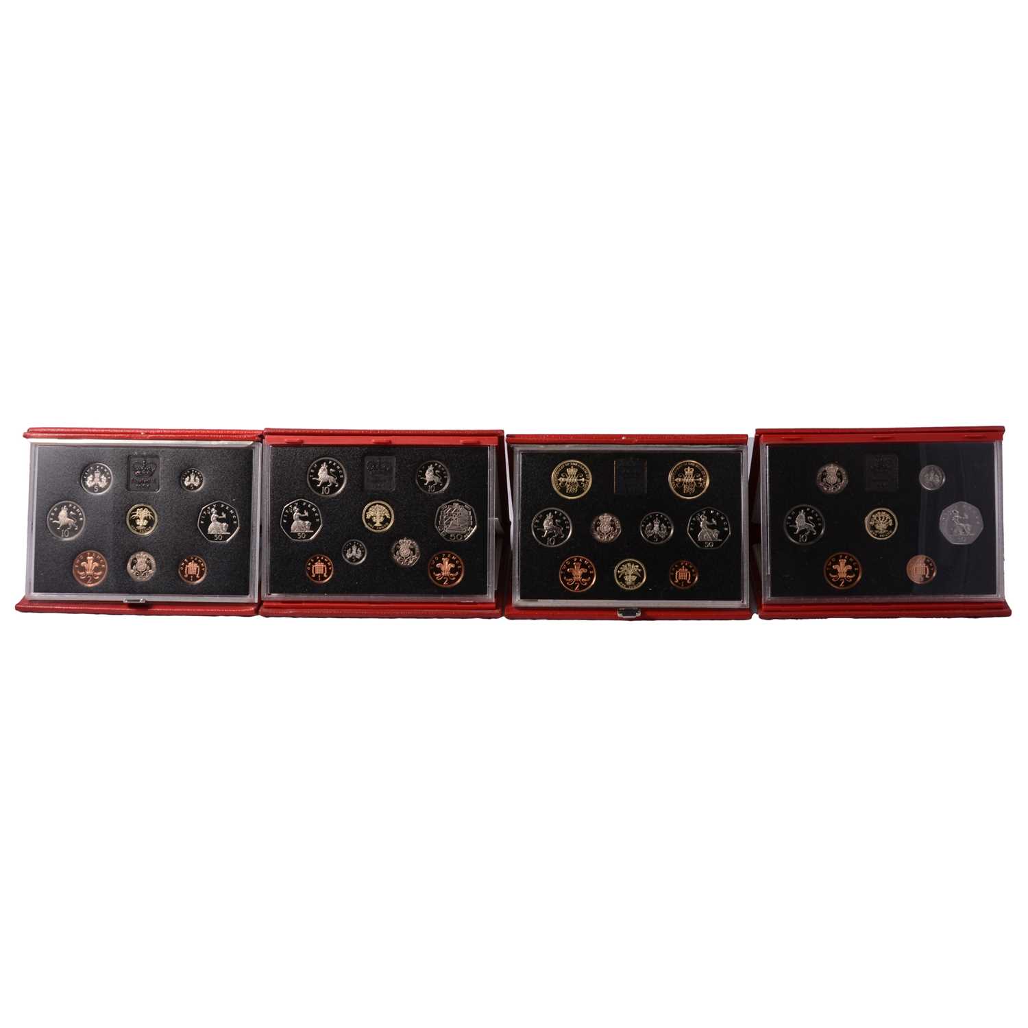 Lot 272 - Four red deluxe proof coin sets.