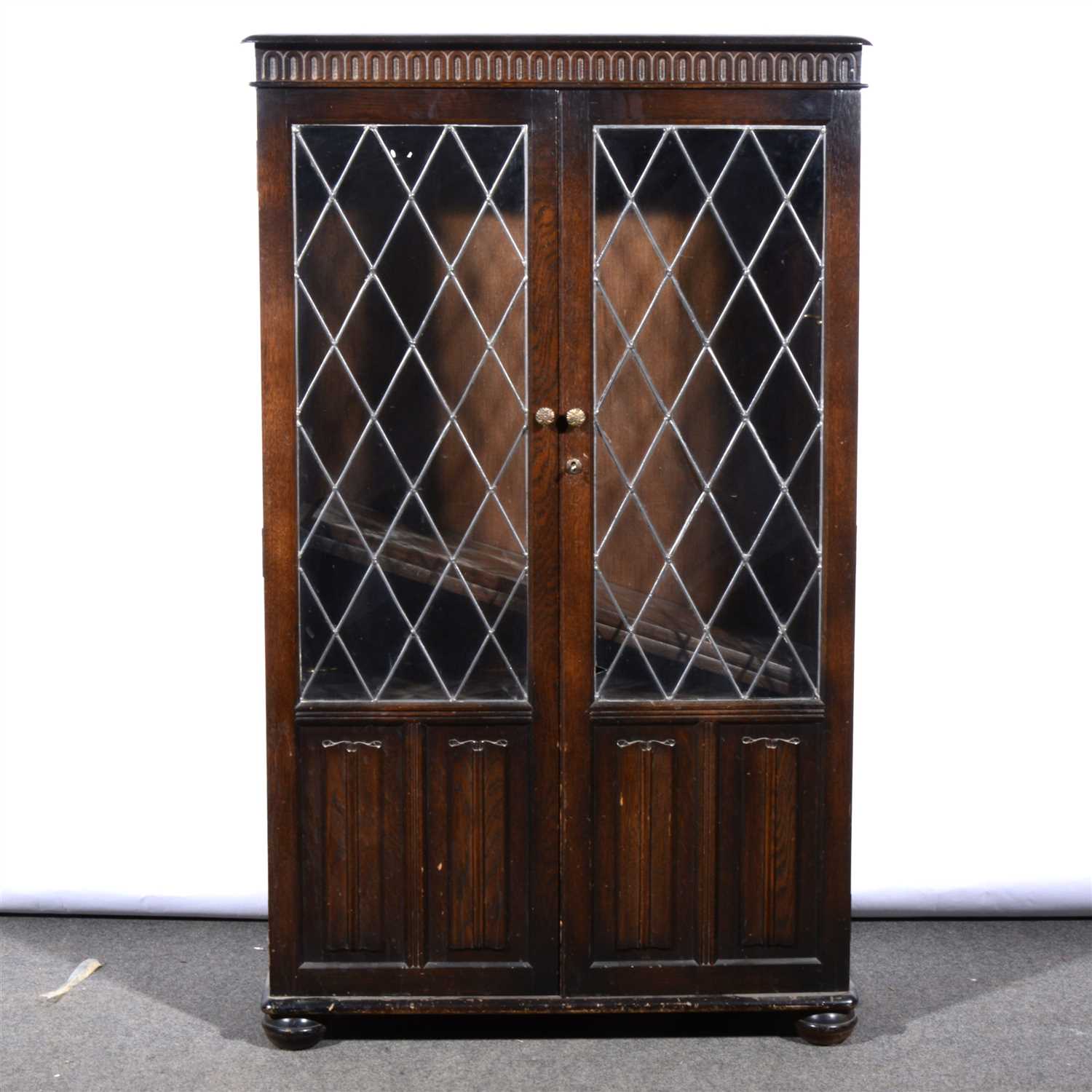Lot 613 - A reproduction stained oak bookcase,
