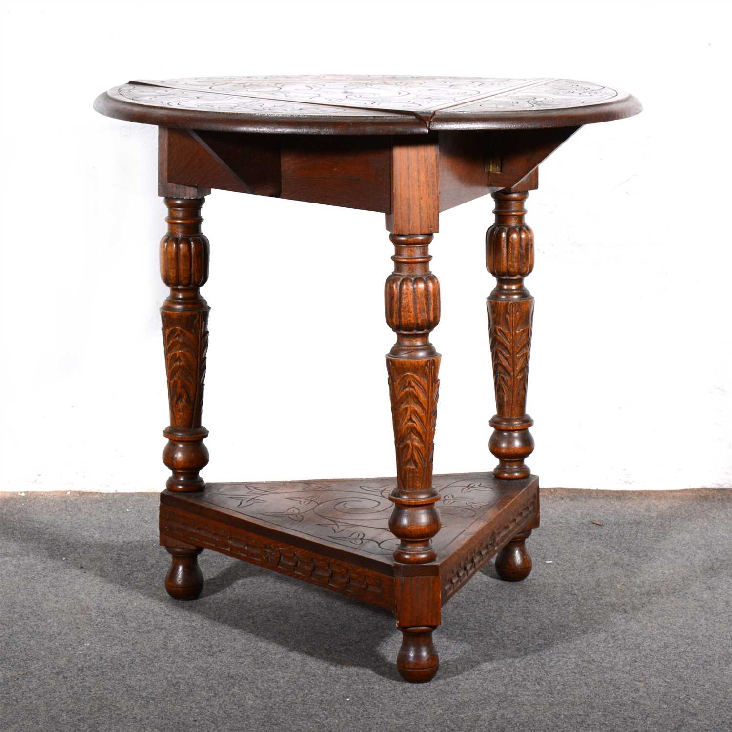 Lot 605 - A late Victorian carved oak triangular