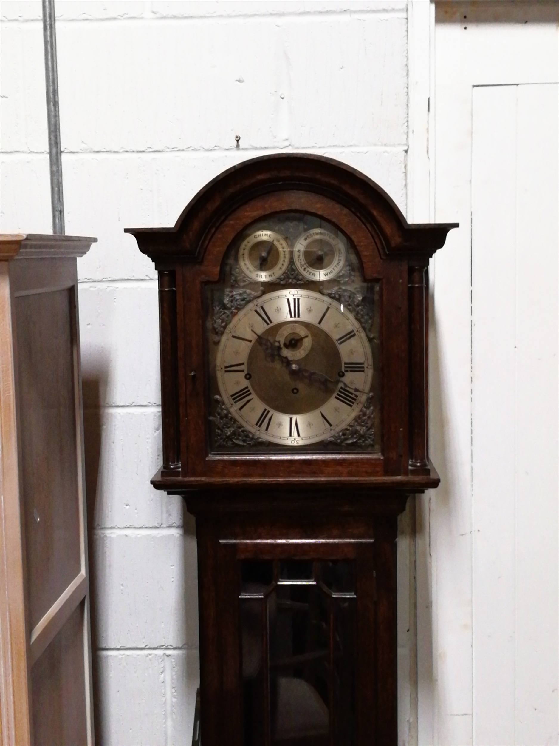 Lot 627 - A reproduction oak longcase clock,