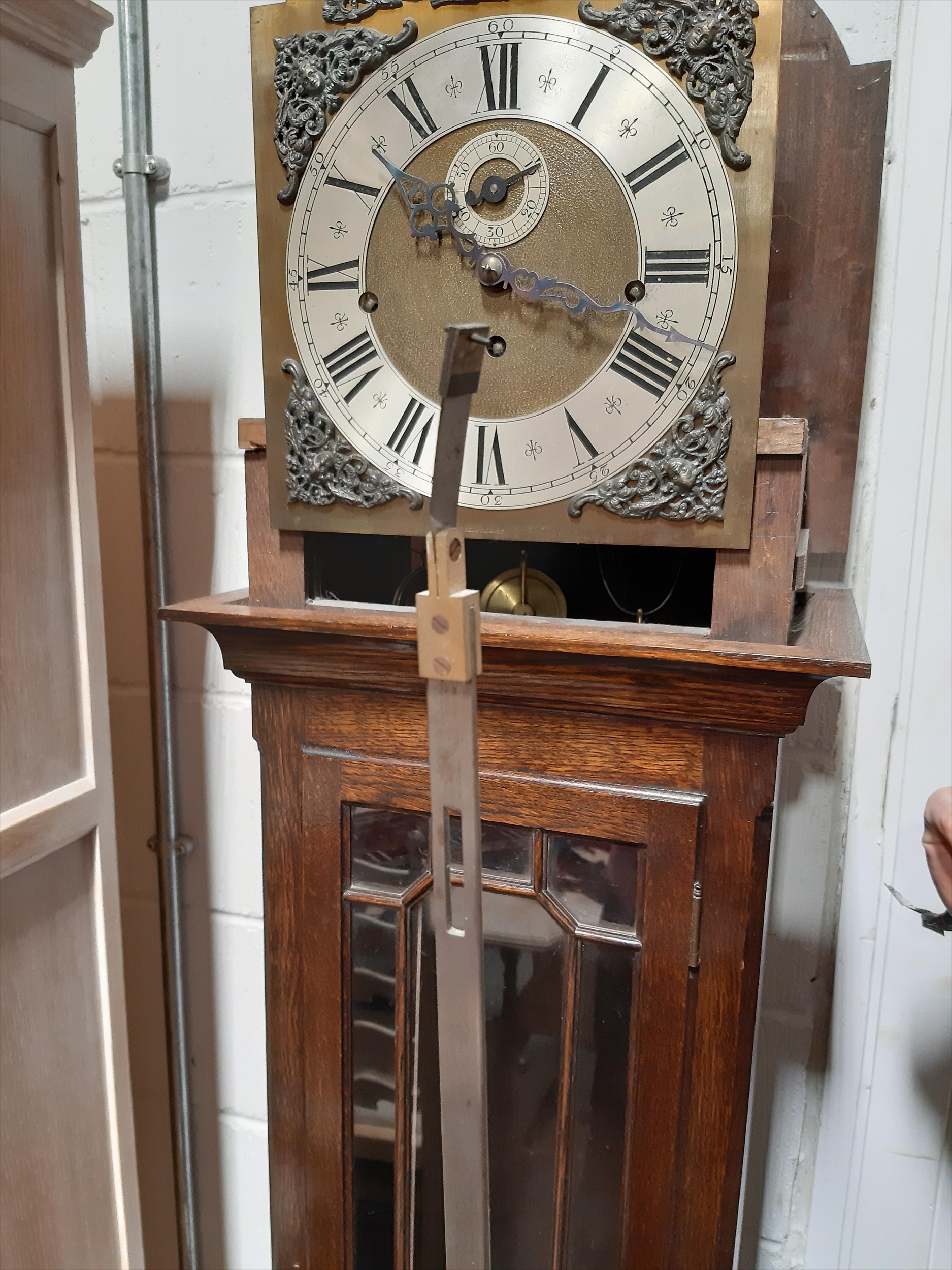 Lot 627 - A reproduction oak longcase clock,