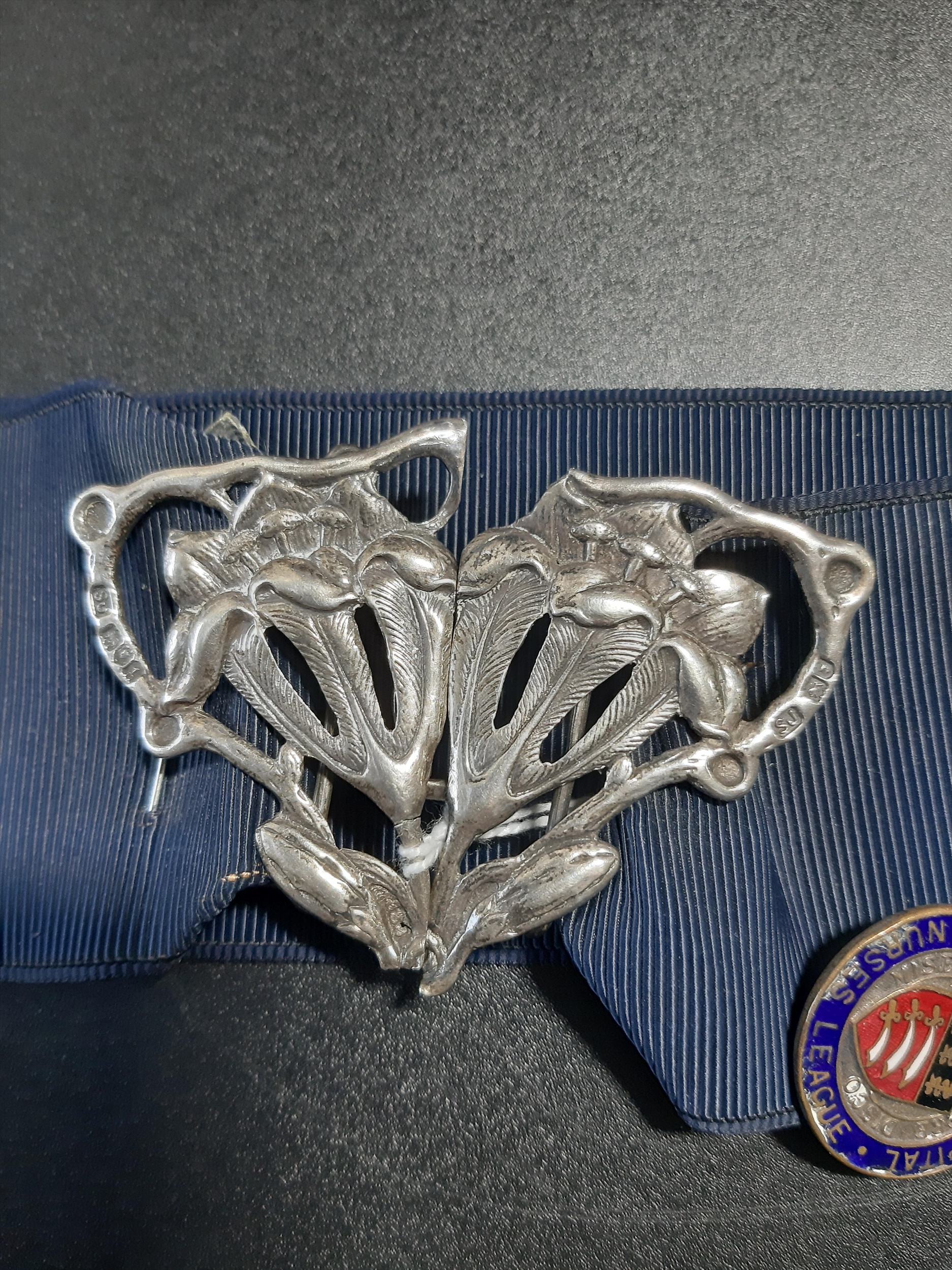 Lot 244 - An Art Nouveau silver nurses buckle.