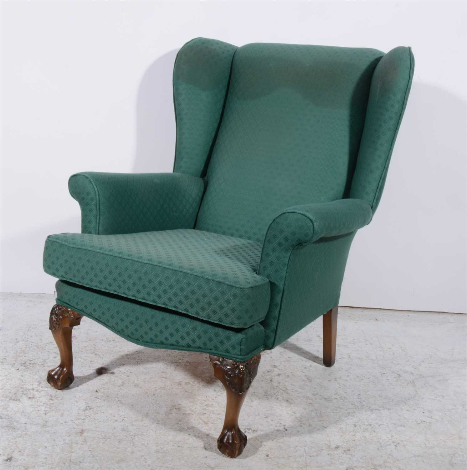 Lot 396 - A reproduction wing-back easychair