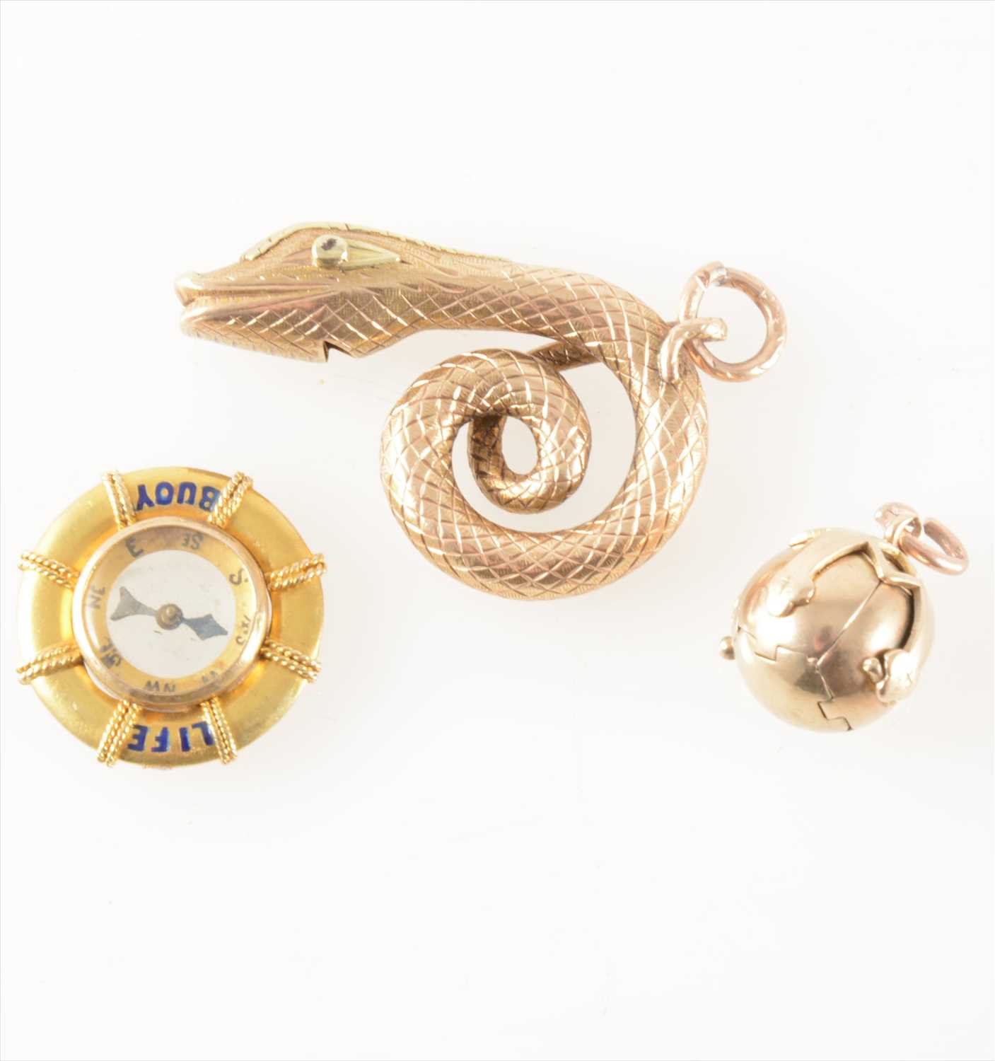 Lot 330 - Three vintage charms, a snake whistle, Life
