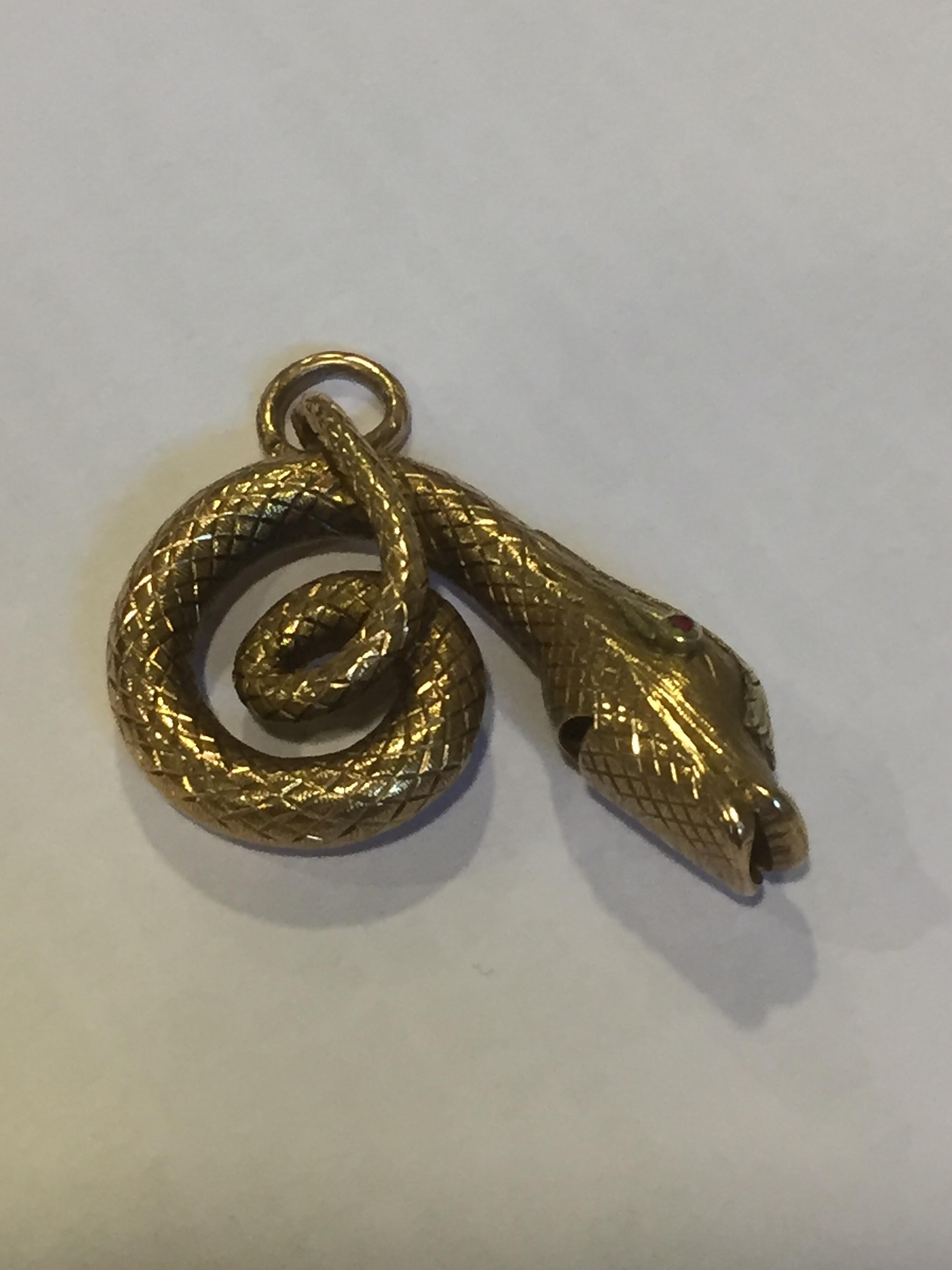 Lot 330 - Three vintage charms, a snake whistle, Life
