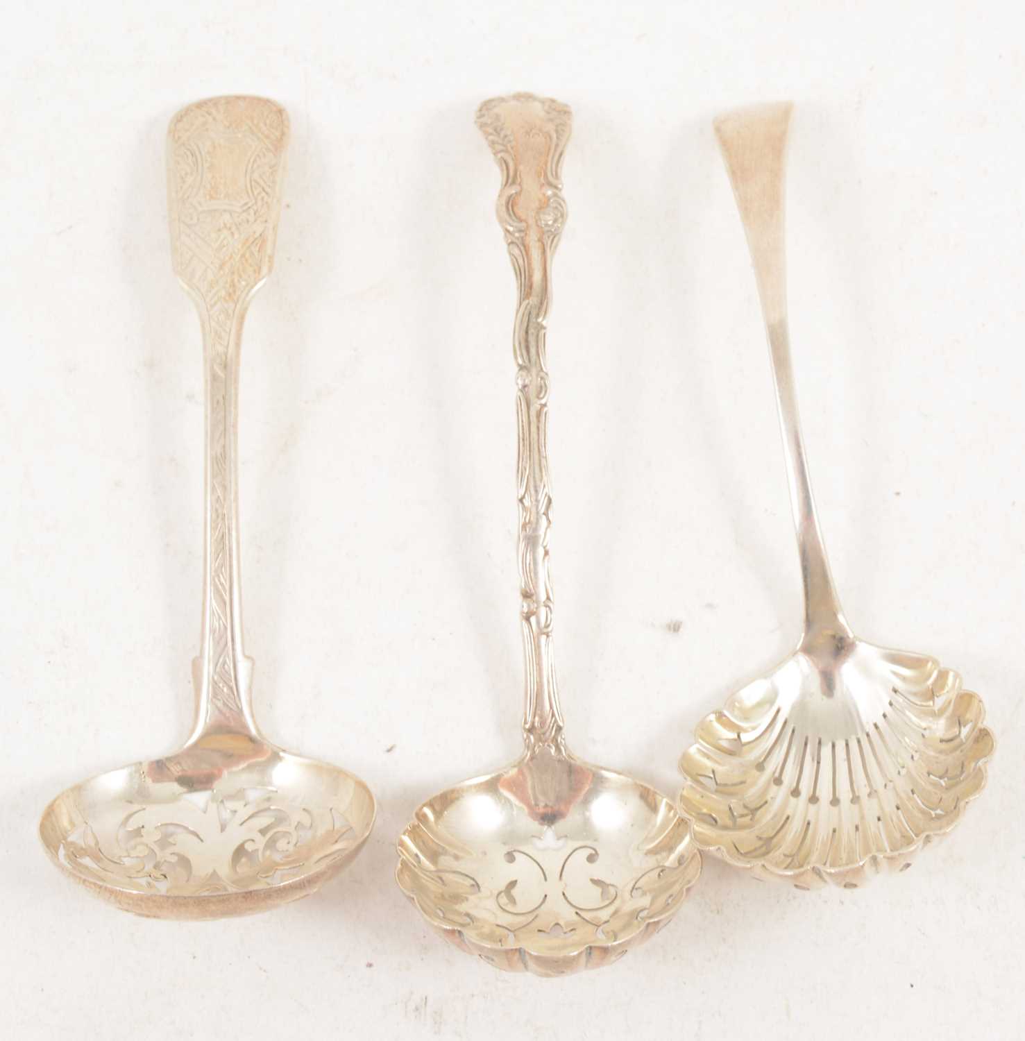 Lot 1205 - Three silver sugar sifting spoons,