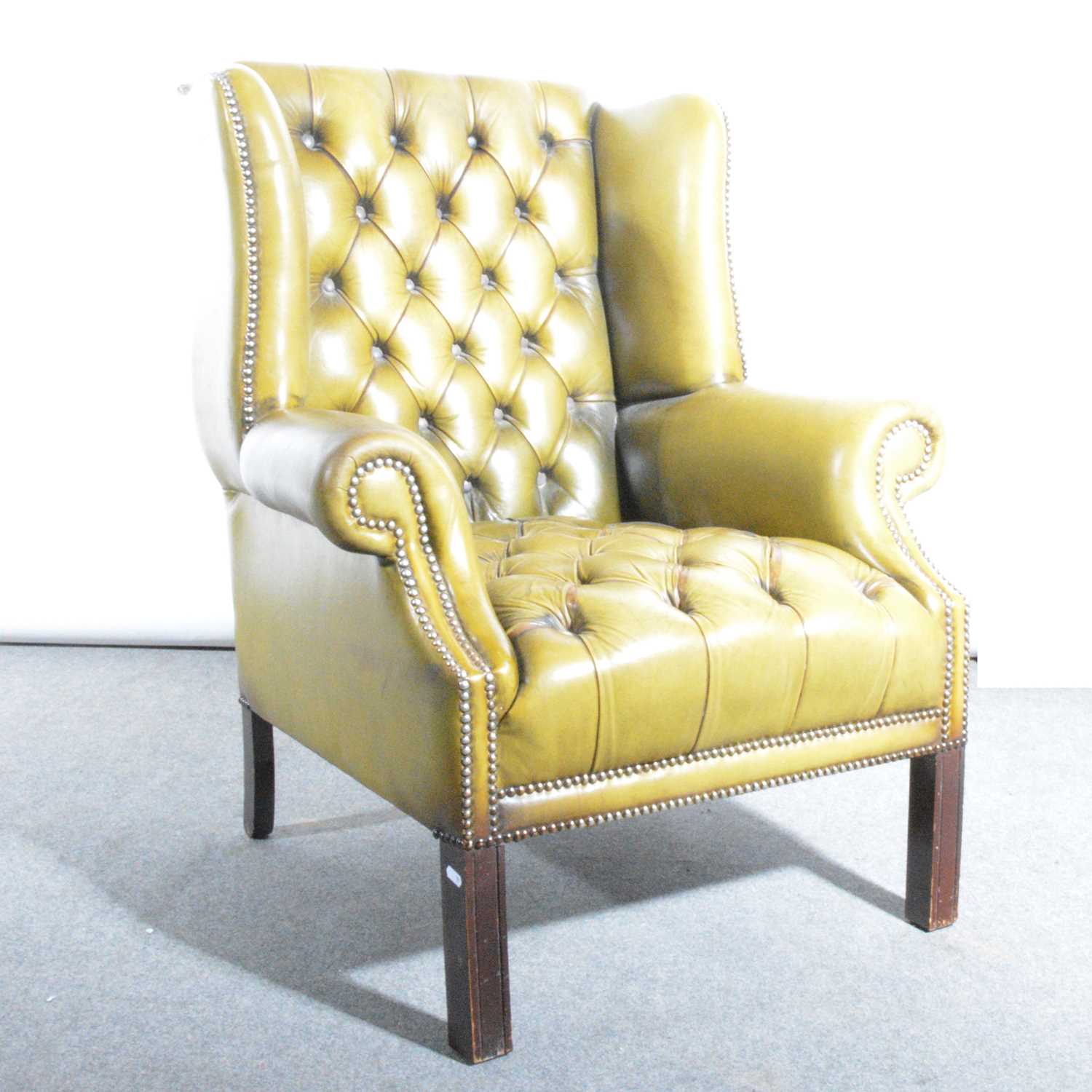 Lot 517 - A modern leather wingback chair in the