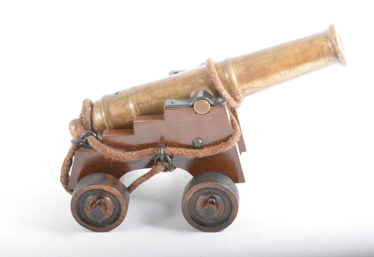 Lot 136 - Gun metal starting cannon, on a stained wood