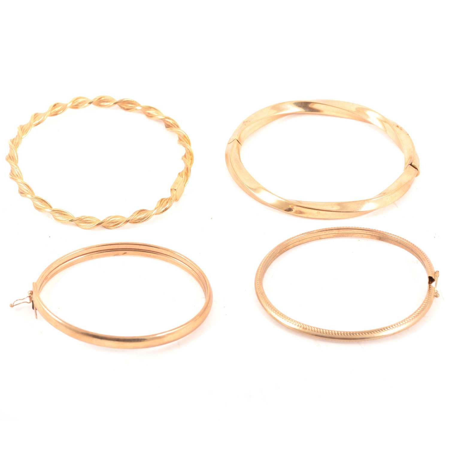 Lot 196 - Four modern gold bangles.