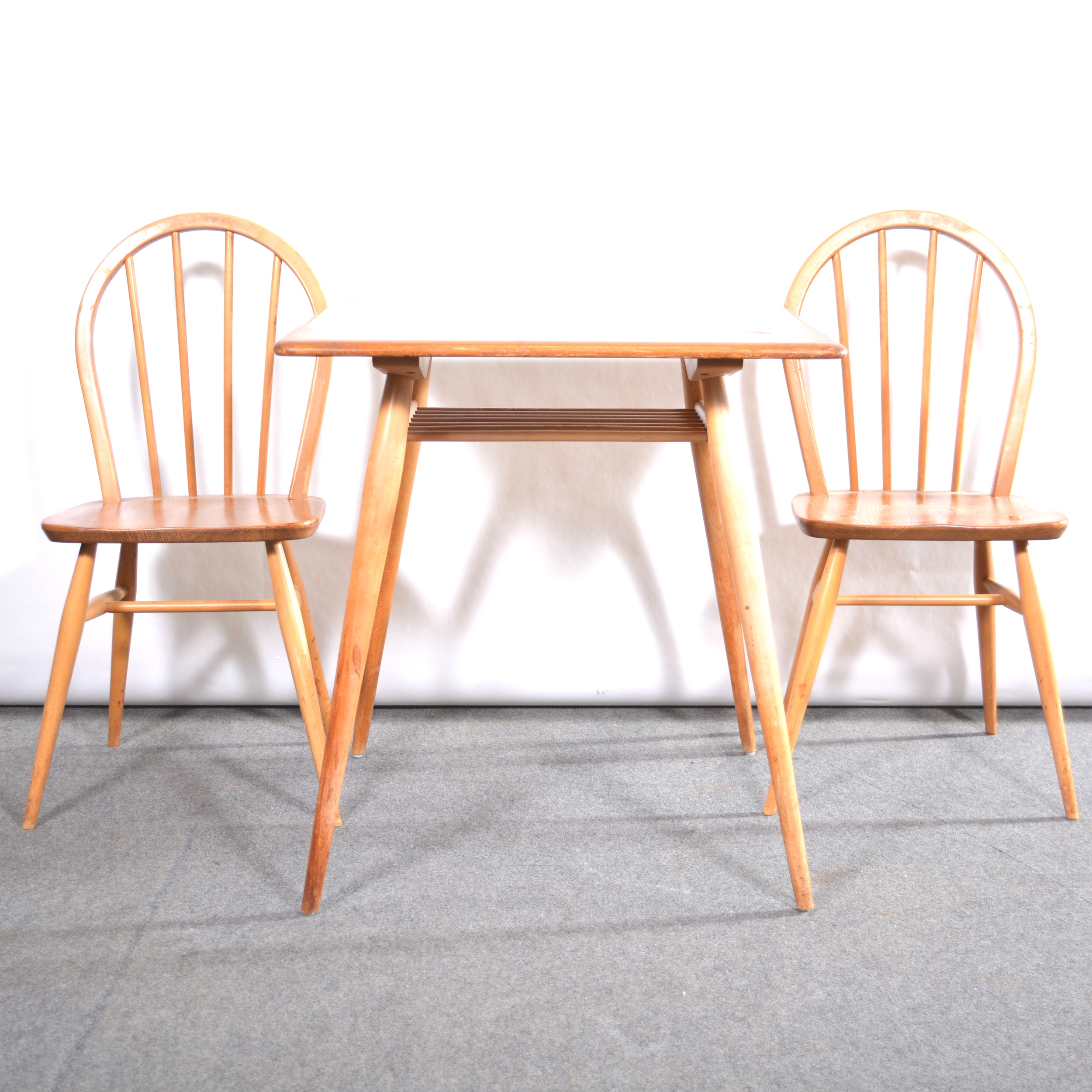 Lot 474 - Ercol kitchen table and two chairs,