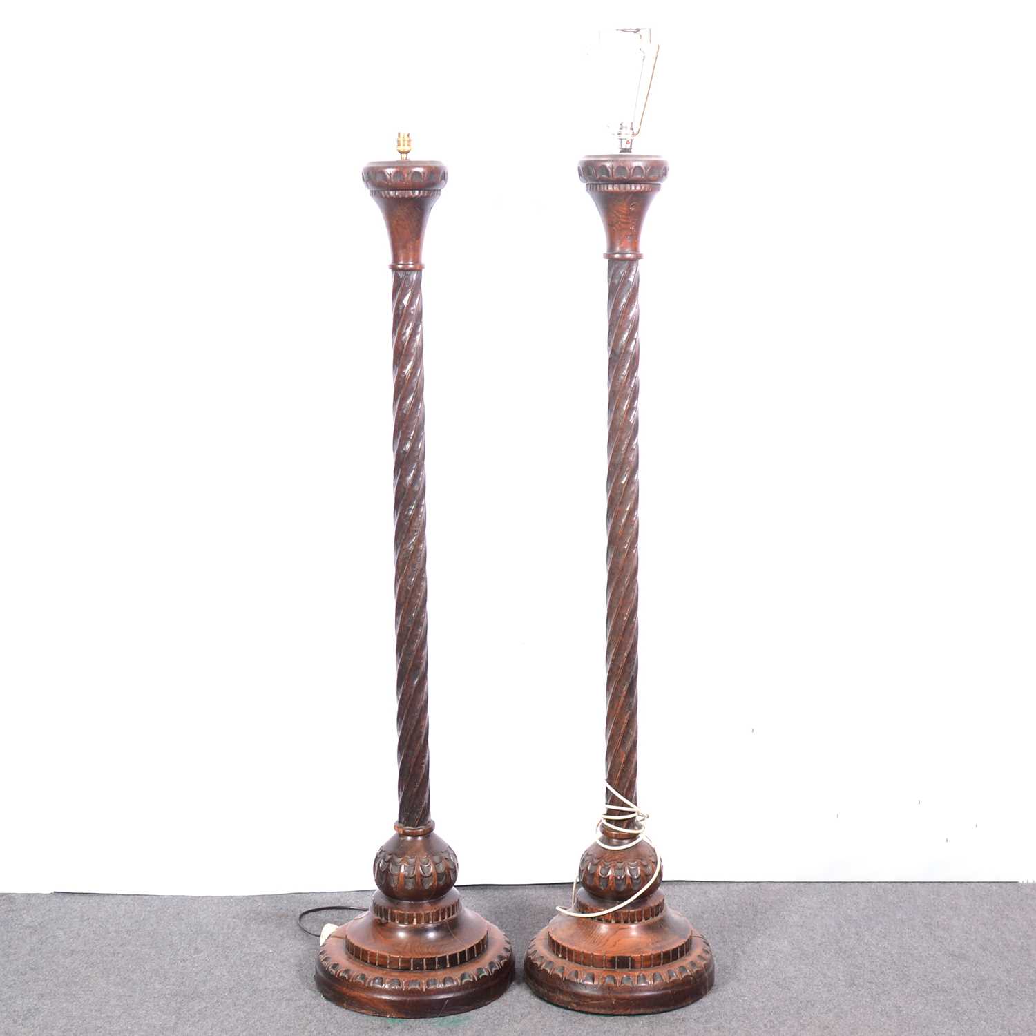 Lot 565 - Pair of carved oak standard lamps,