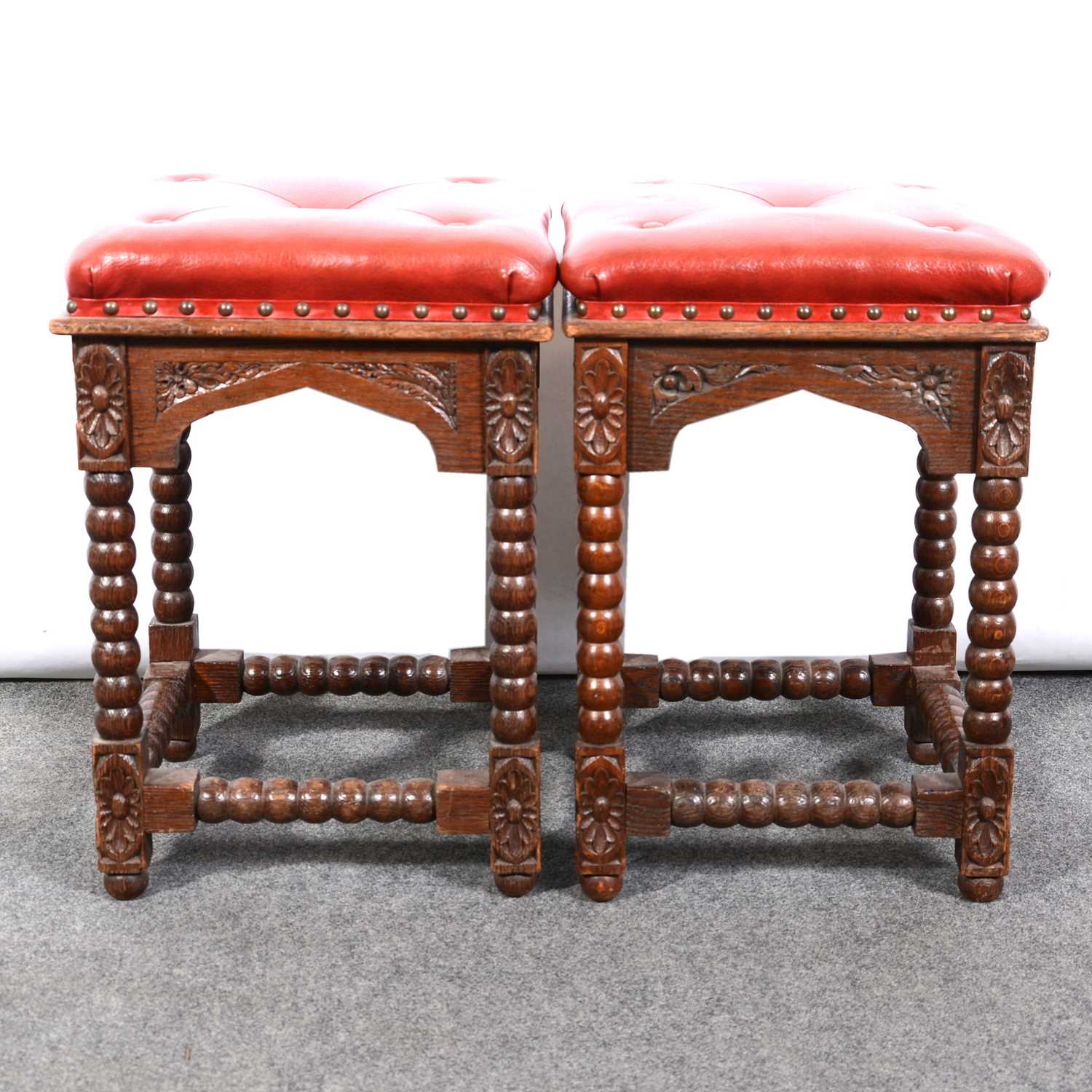 Lot 510 - A pair of oak bobbin turned stools, carved