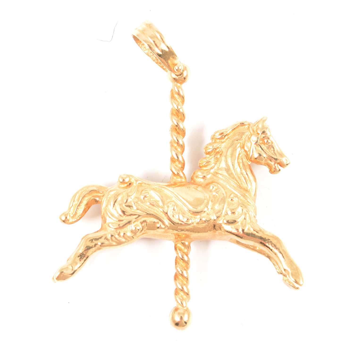 Lot 267 - A 9 carat yellow gold carousel horse pendant.