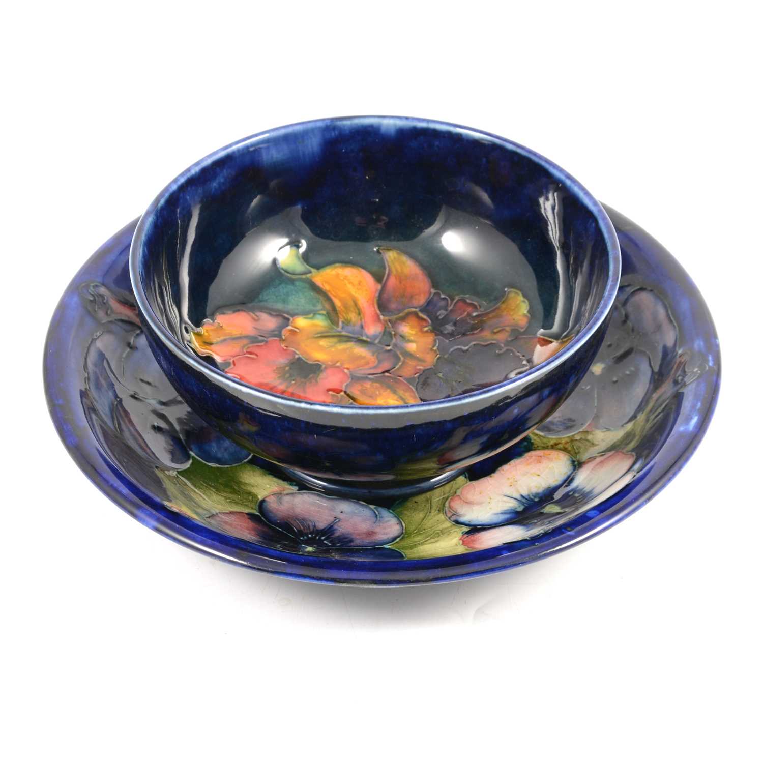 Lot 30 - William Moorcroft - a Pansy shallow dish, and