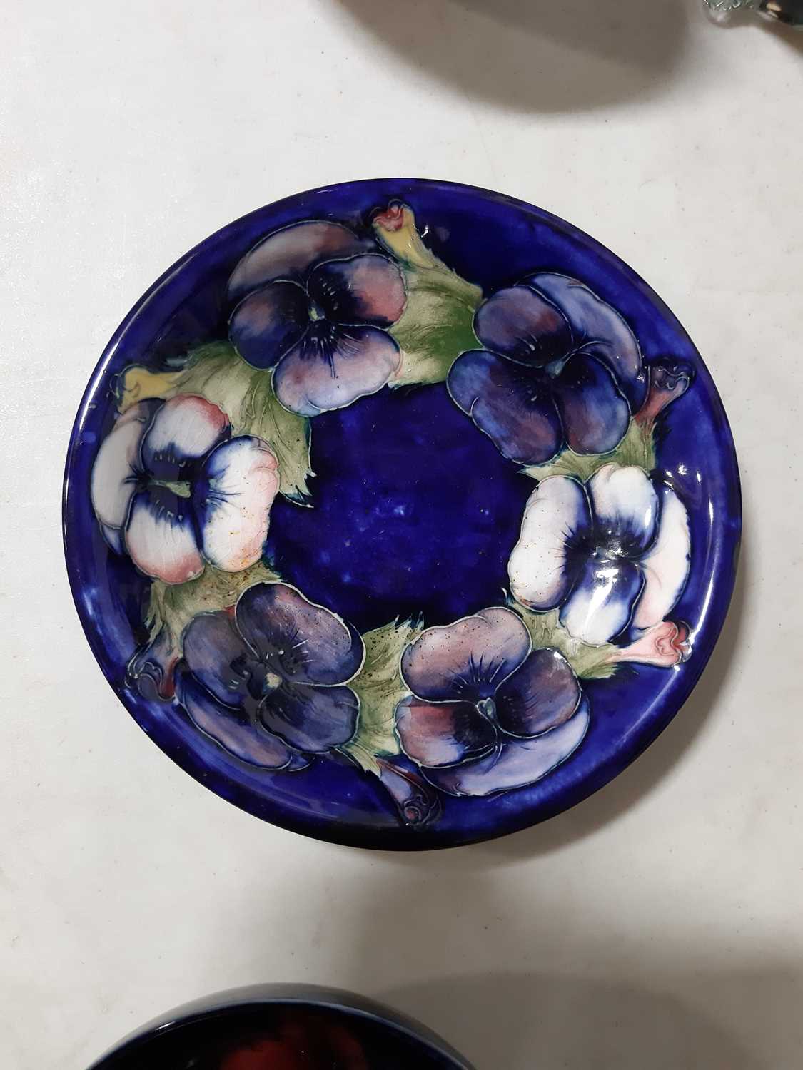 Lot 30 - William Moorcroft - a Pansy shallow dish, and