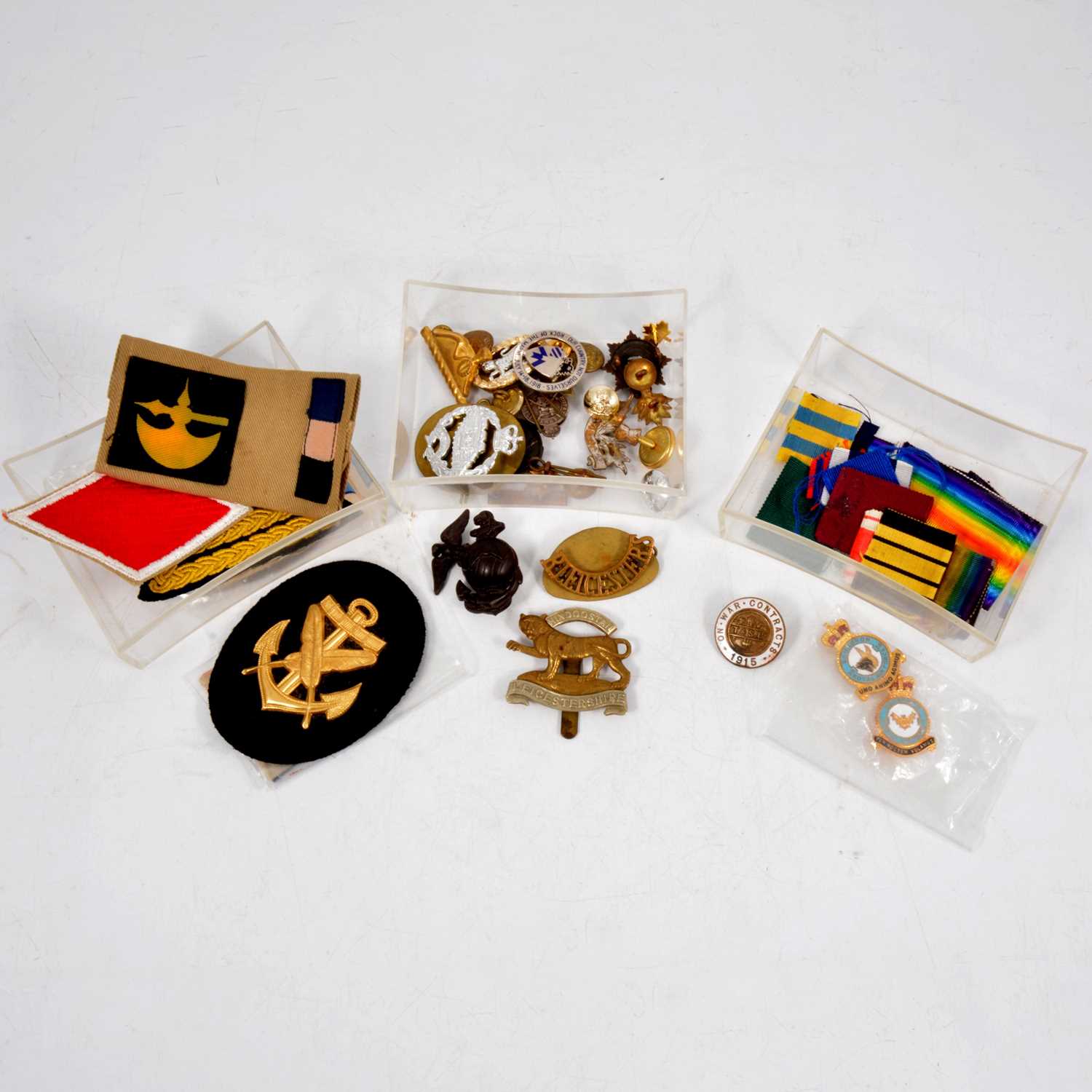 Lot 253 - Three small boxes of military badges,