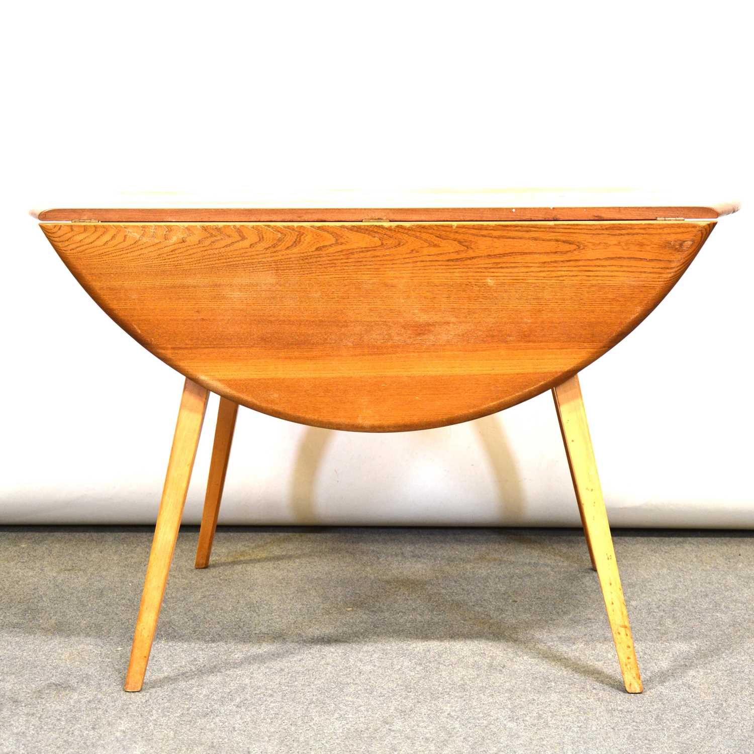 Lot 425 - Ercol, beech and elm drop leaf table and