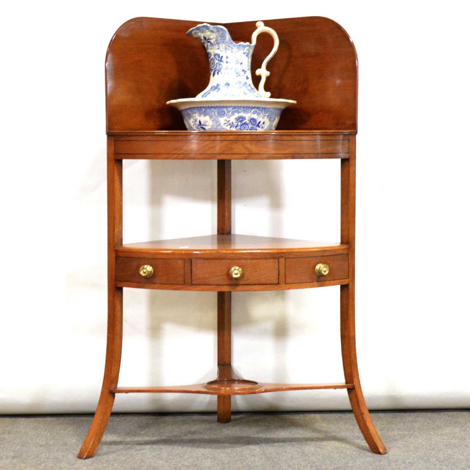 Lot 482 - George III mahogany corner washstand, with