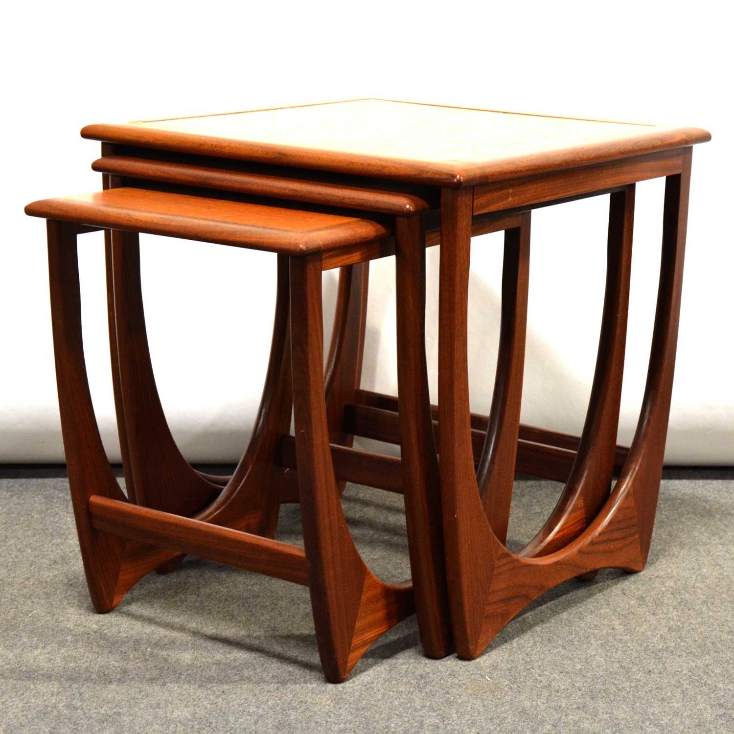 Lot 480 - A nest of three teak G Plan tables with tile